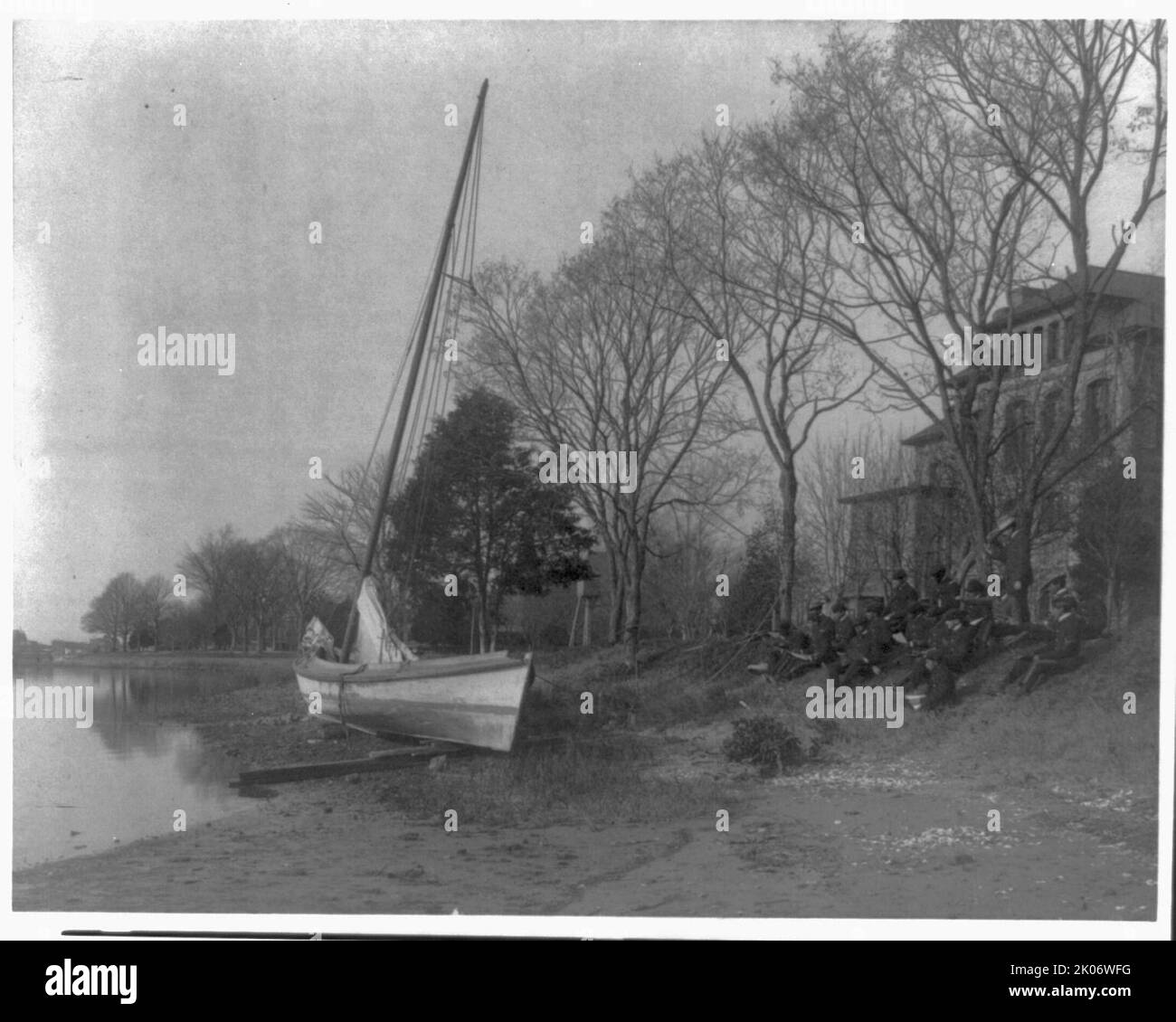 Hampton Institute students sketching a fishing boat at river bank ...