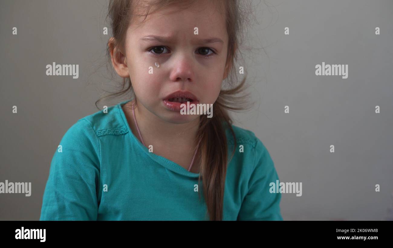 Portrait little girl sad upset child burst into tears cries sob looking ...