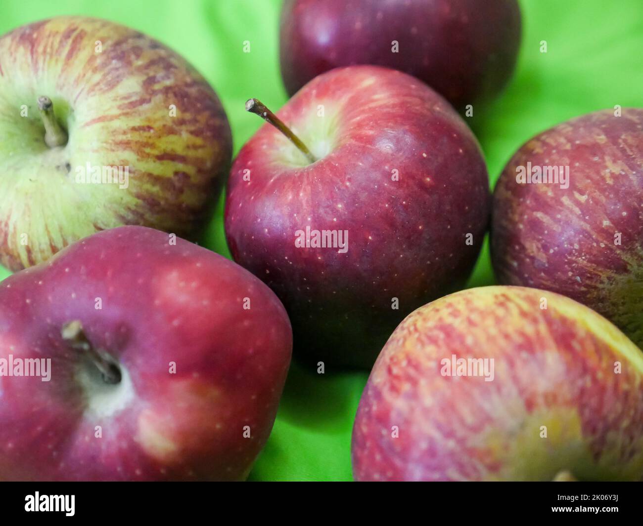 Juicy whole Apple in green background Stock Photo - Alamy