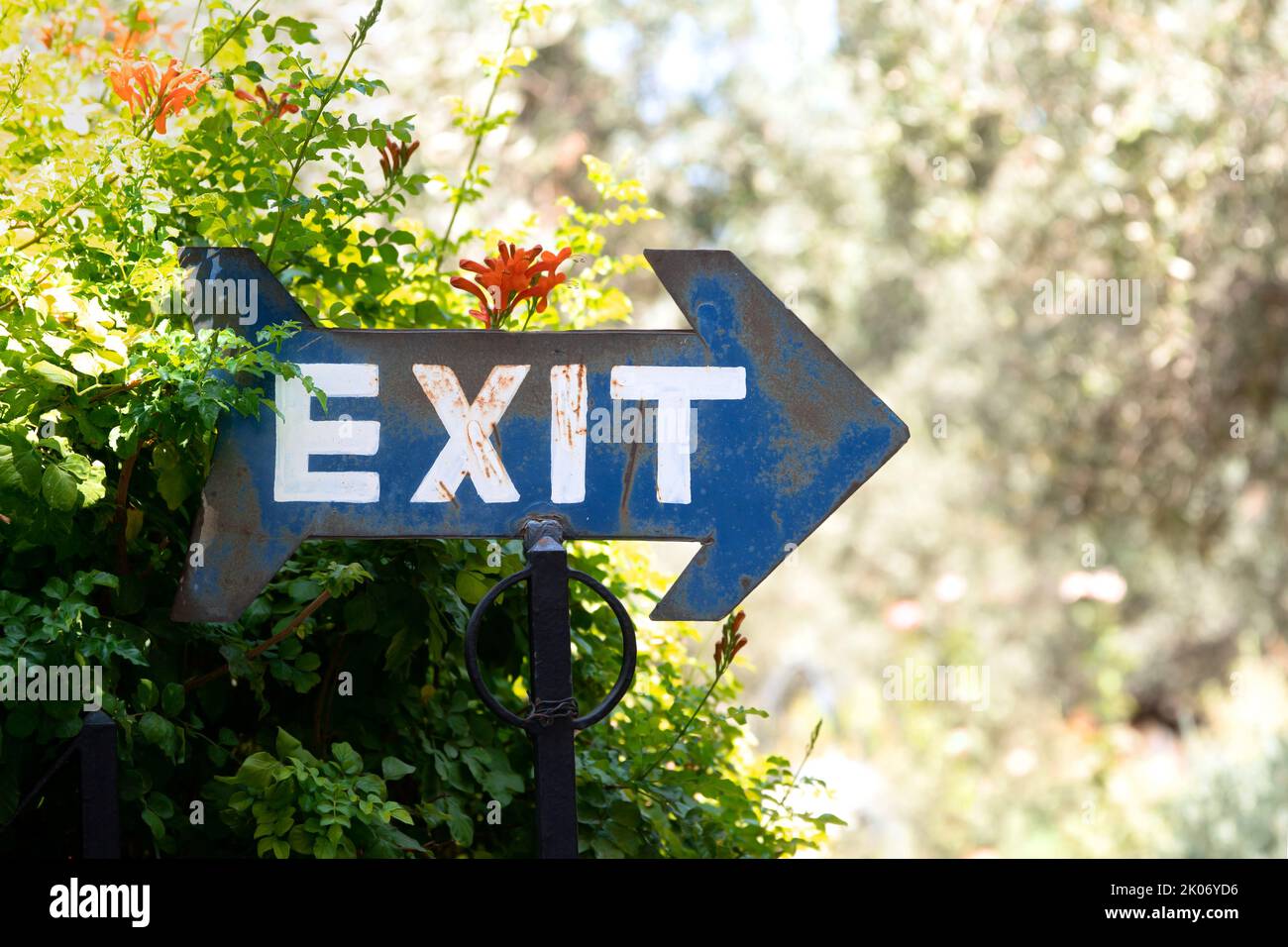 Exit sign metal plate in the shape of an arrow outdoors Stock Photo - Alamy