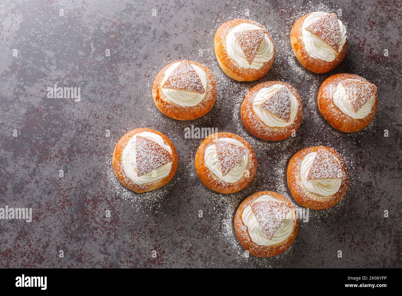 Scandinavian sweet buns stuffed with frangipane and whipped cream close ...