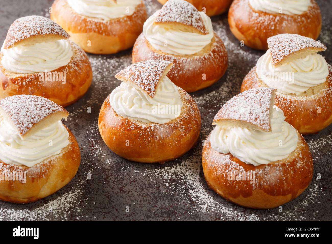 Scandinavian sweet buns stuffed with frangipane and whipped cream close ...