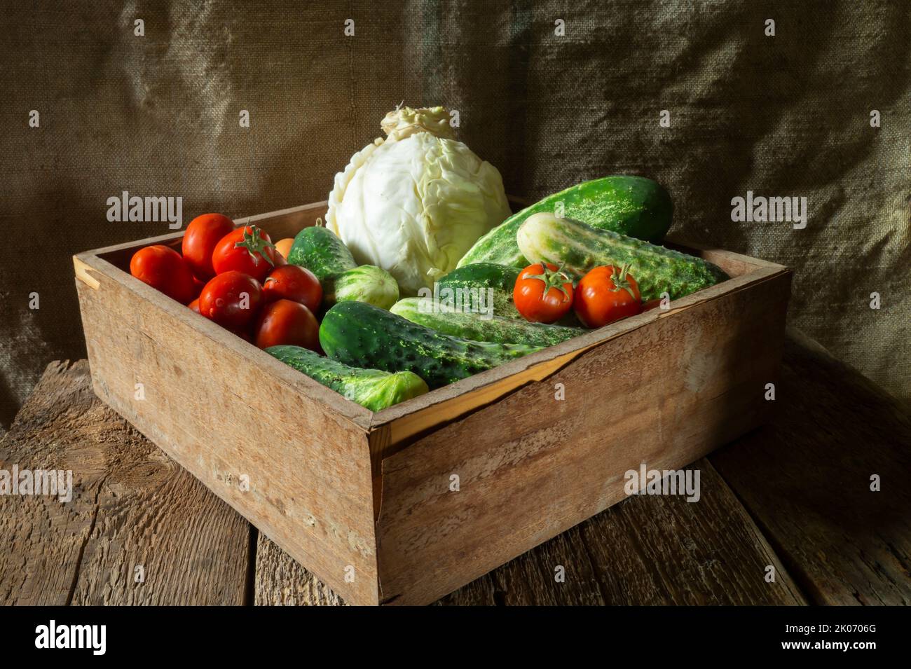 Still life of ripe vegetables in an old box. Food products on the ...