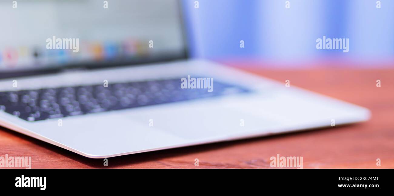 Open laptop on the table. Blurred laptop screen while working. Device ...