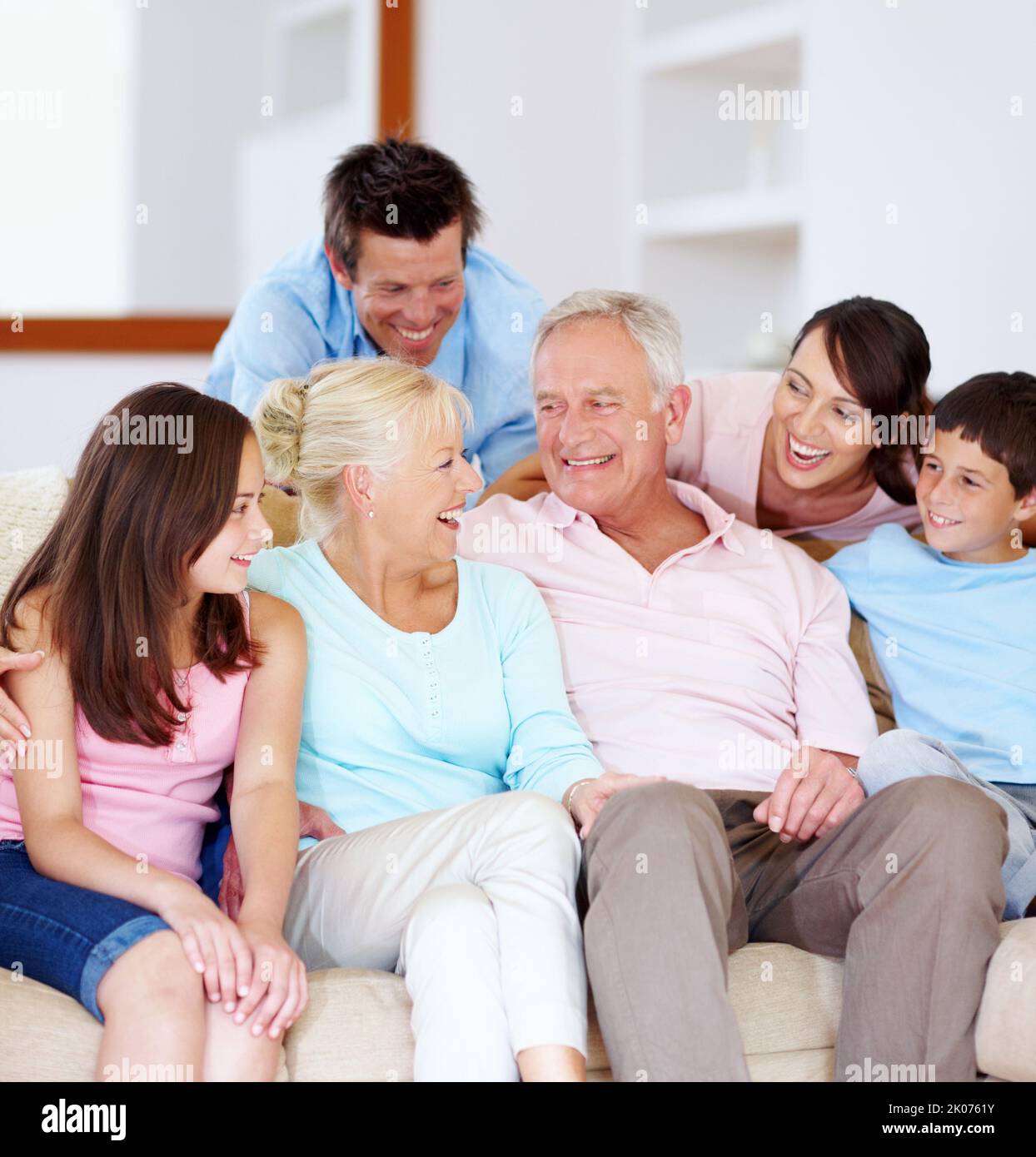 Laughter, love and affection. A loving family laughing on a lounge sofa ...