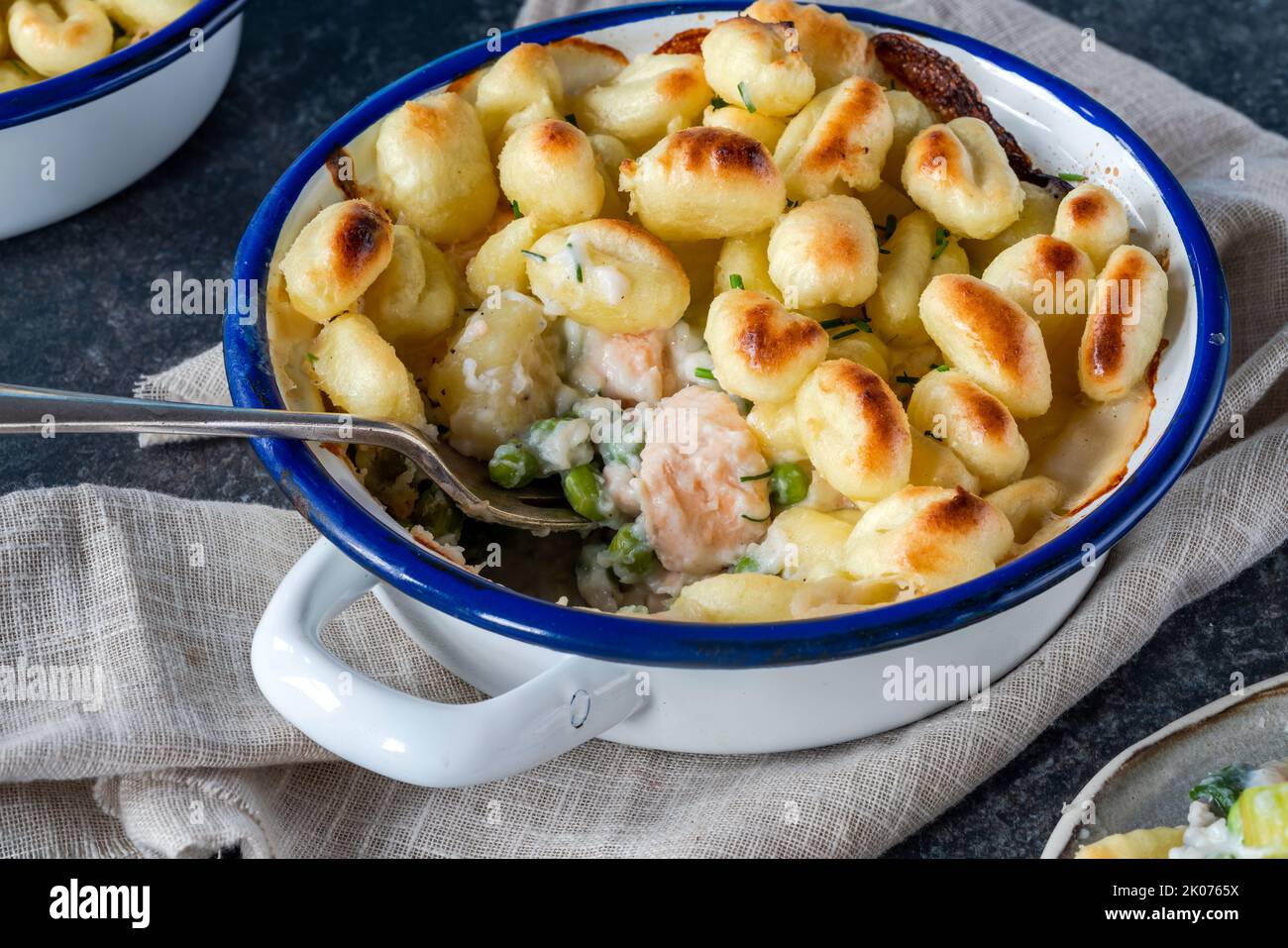 Fish pie with baked potato gnocchi topping Stock Photo - Alamy