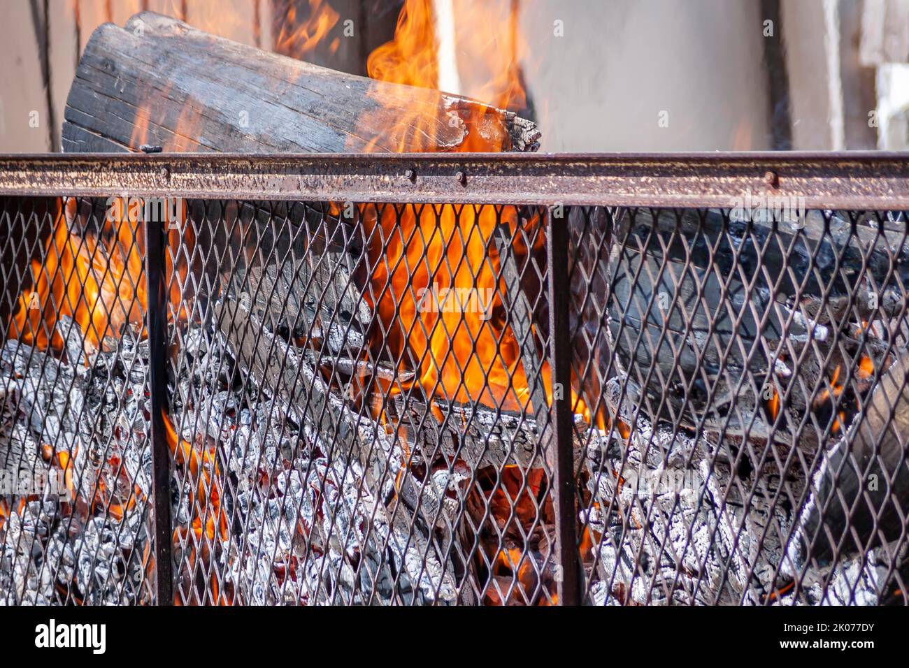 Fire, burning of waste, waste wood in lattice box Stock Photo - Alamy