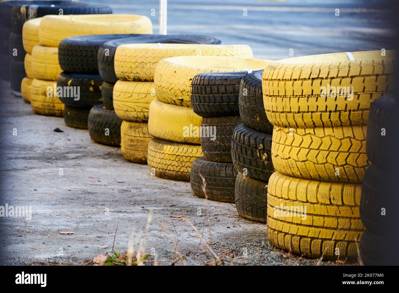 Car tires black and yellow, for racing track fencing Stock Photo - Alamy