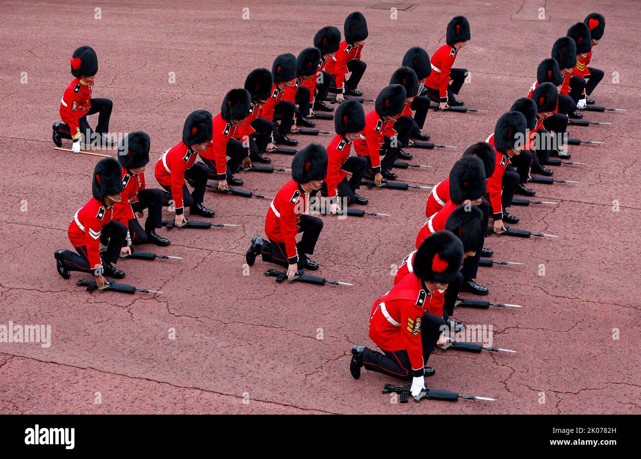 Members of the Coldstream guards kneel and place their rifles on the ...