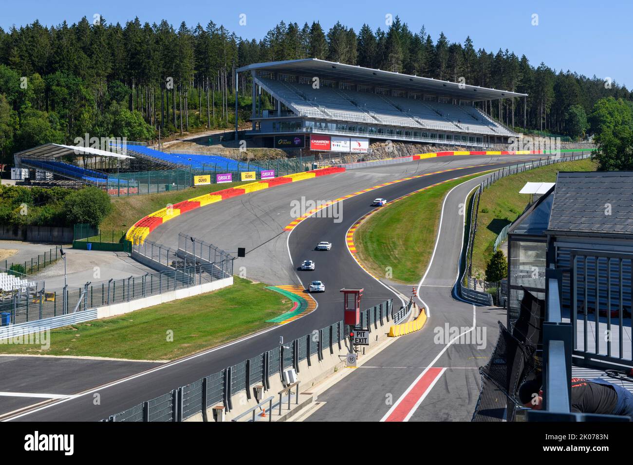 View of four racing cars racing through dangerous Eau Rouge bend on 40 ...