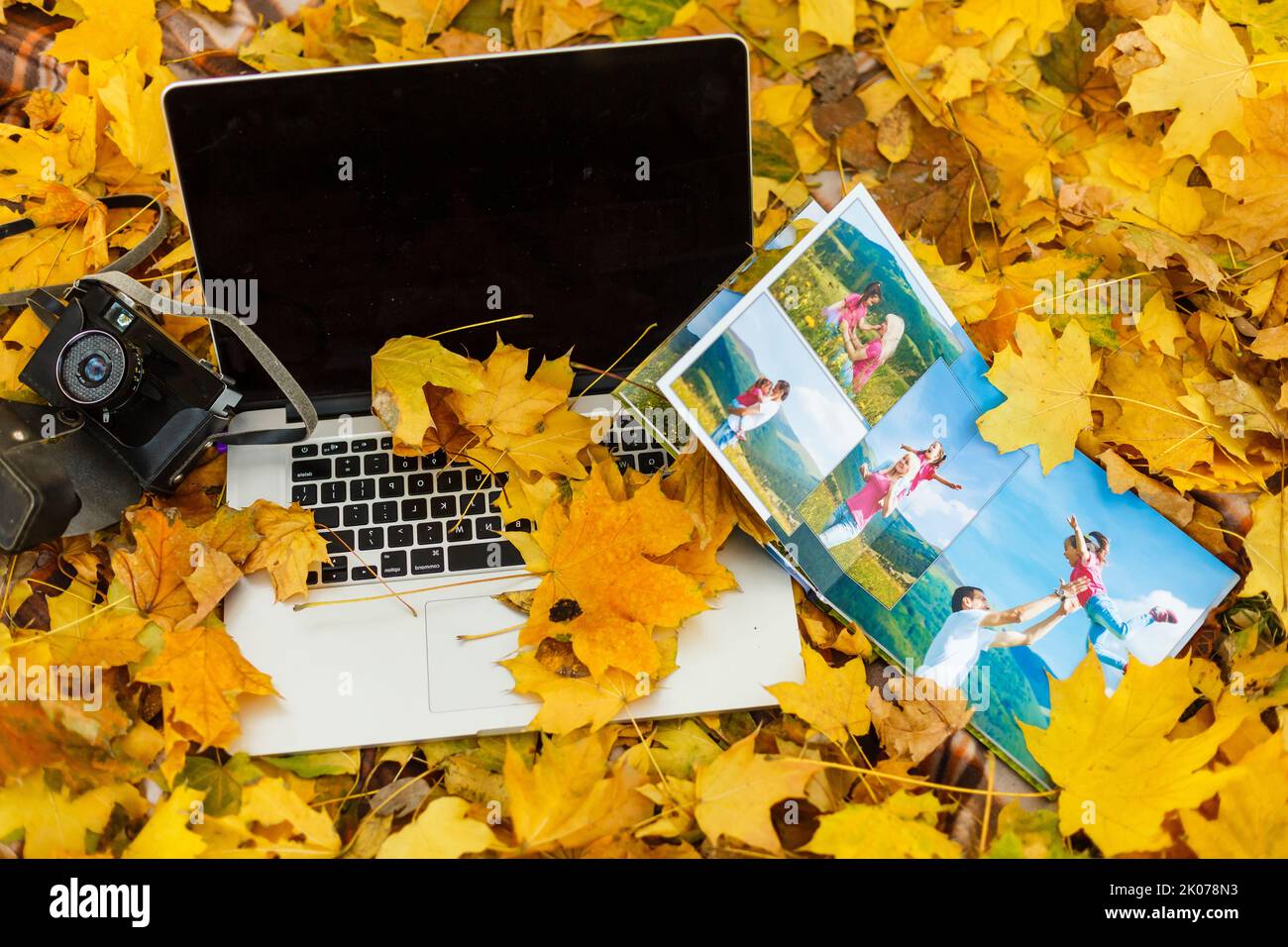 elegant photobook and laptop, autumn photo album Stock Photo - Alamy