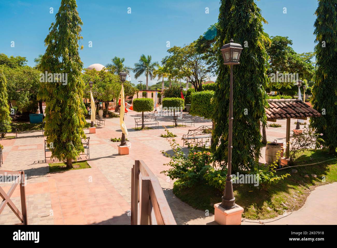 View of a nice urban park surrounded by green trees on a sunny day ...