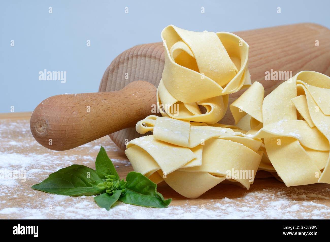 Pappardelle, wide Italian ribbon noodles with dough roll, pasta Stock ...
