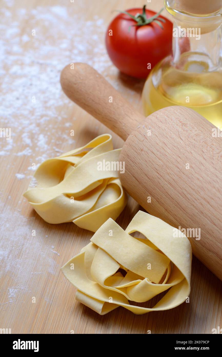 Pappardelle, wide Italian ribbon noodles with dough roll, pasta Stock ...
