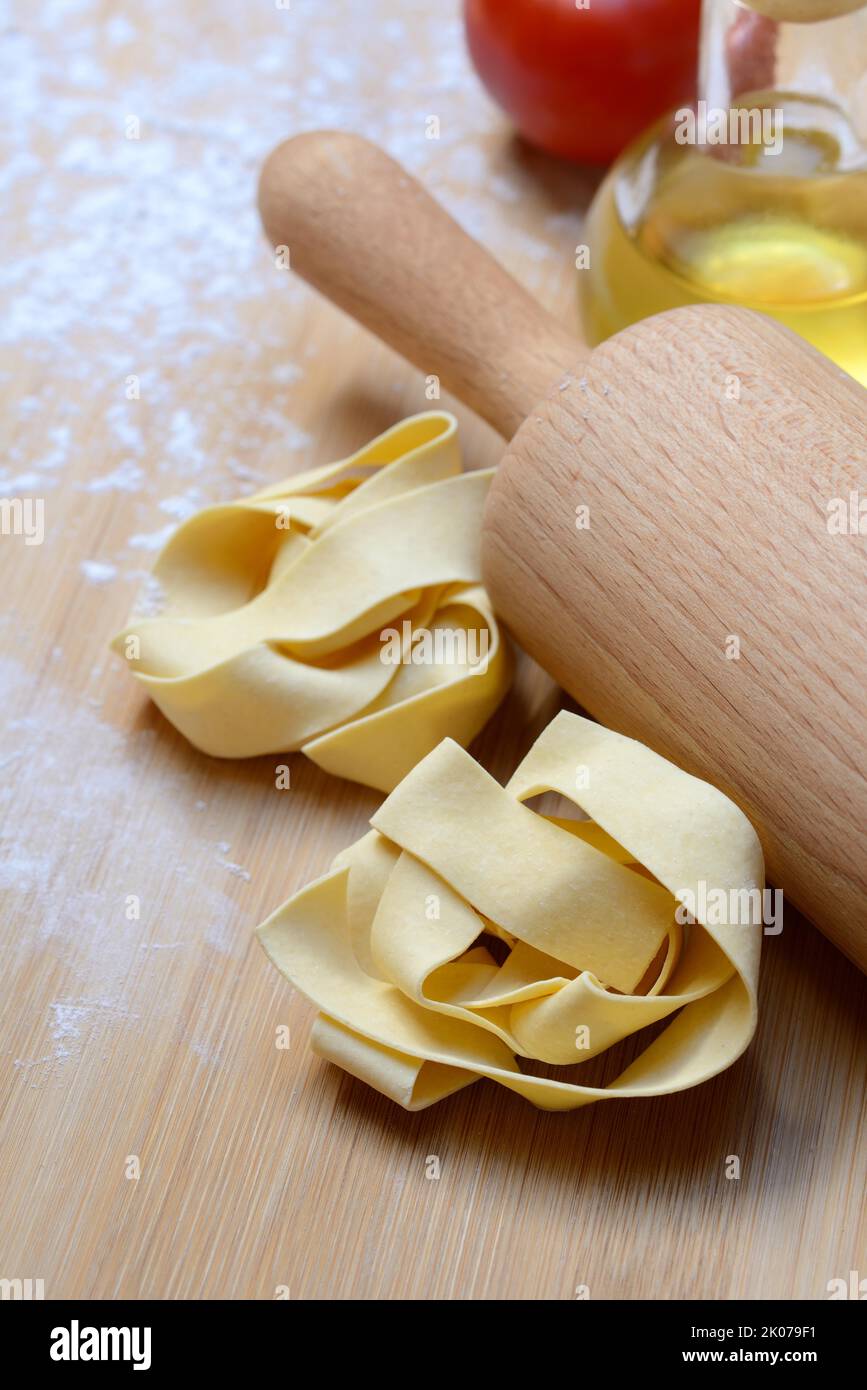 Pappardelle, wide Italian ribbon noodles with dough roll, pasta Stock ...