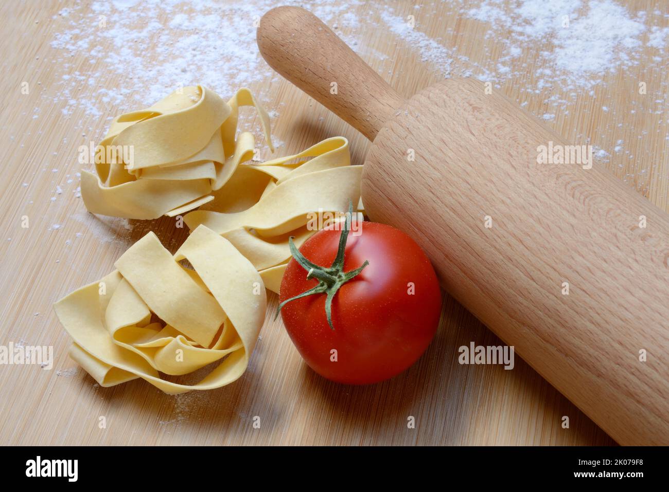Pappardelle, wide Italian ribbon noodles with dough roll, pasta Stock ...