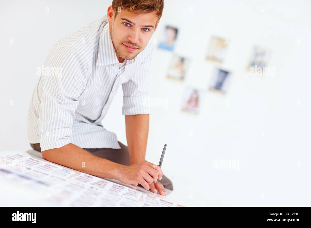 Handsome photographer sitting on table. Portrait of handsome ...