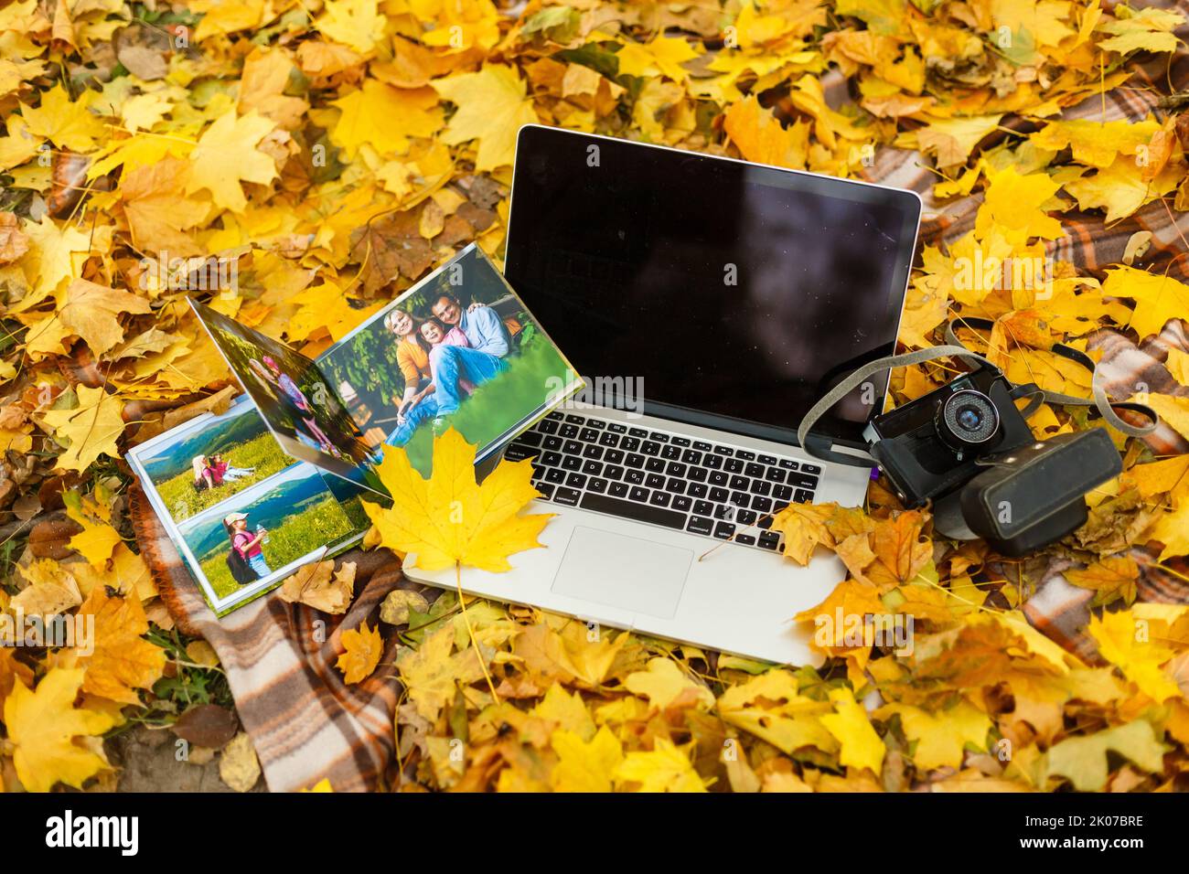 elegant photobook and laptop, autumn photo album Stock Photo - Alamy