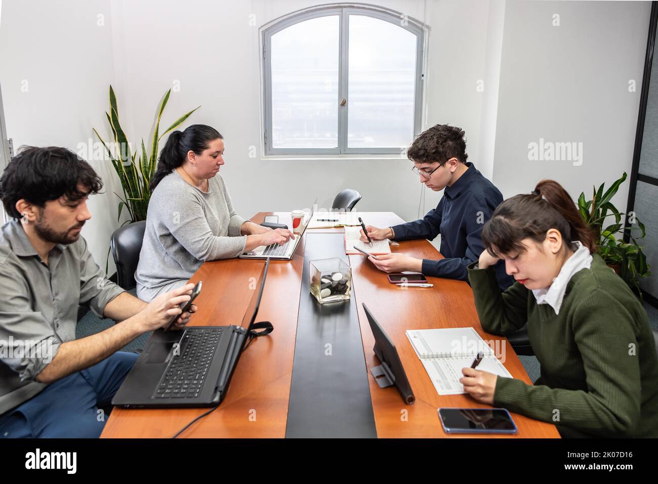 People working on laptops during a meeting Stock Photo - Alamy