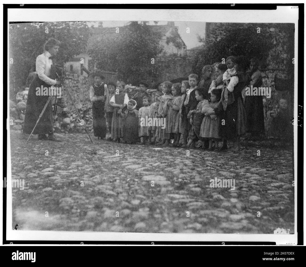 Frances Benjamin Johnston photographing a group of people, mostly ...