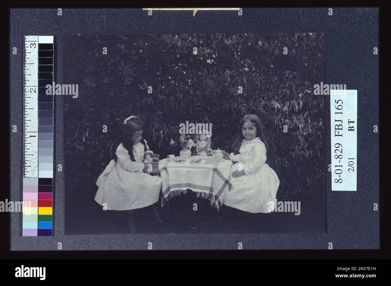 Afternoon tea, c1900. Photograph shows two girls having a tea party ...