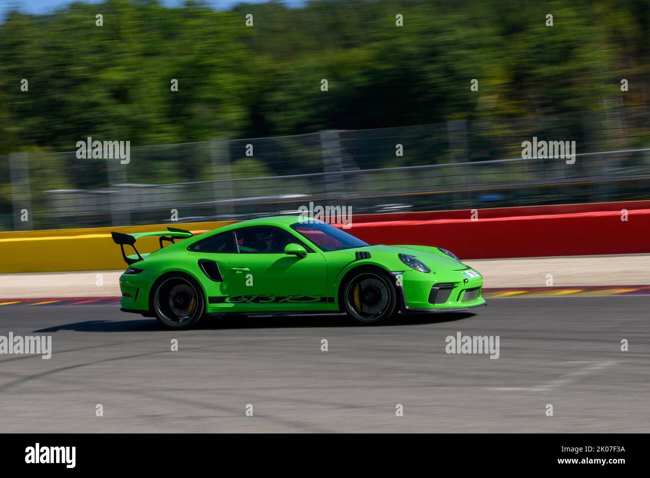 Green racing car sports car Porsche 911 GT3 RS races at high speed full ...