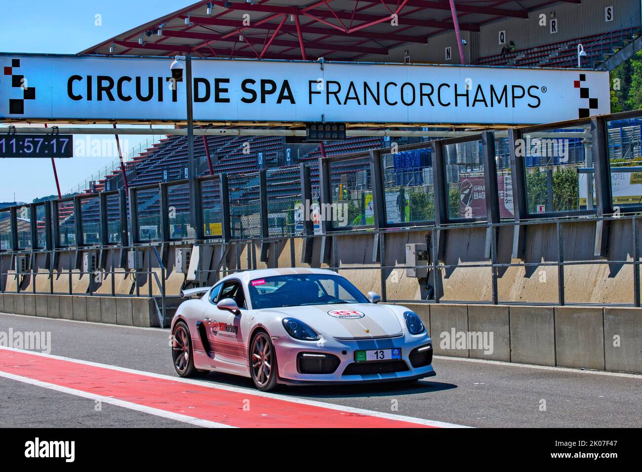 Racing car Sports car Porsche Cayman GT4 drives through pit lane Pit ...