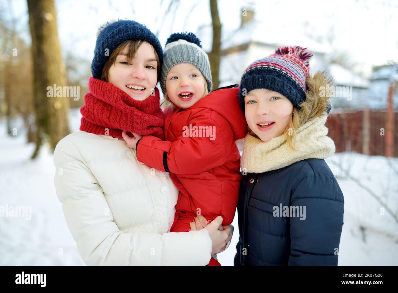 Two big sisters and their toddler brother having fun outdoors. Two ...