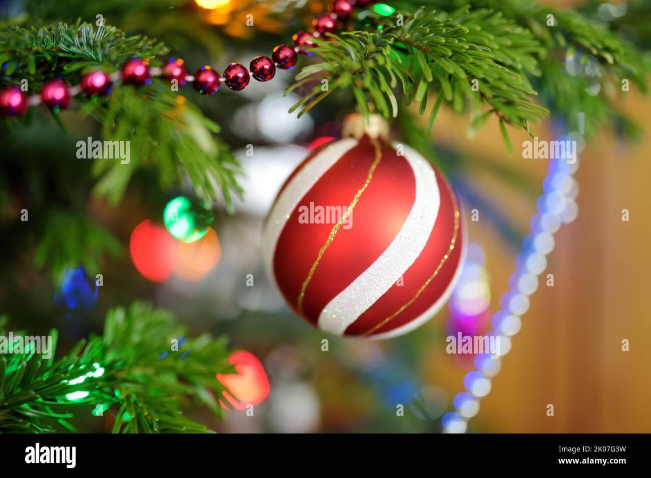Christmas baubles on christmas tree on lights background. Celebrating ...