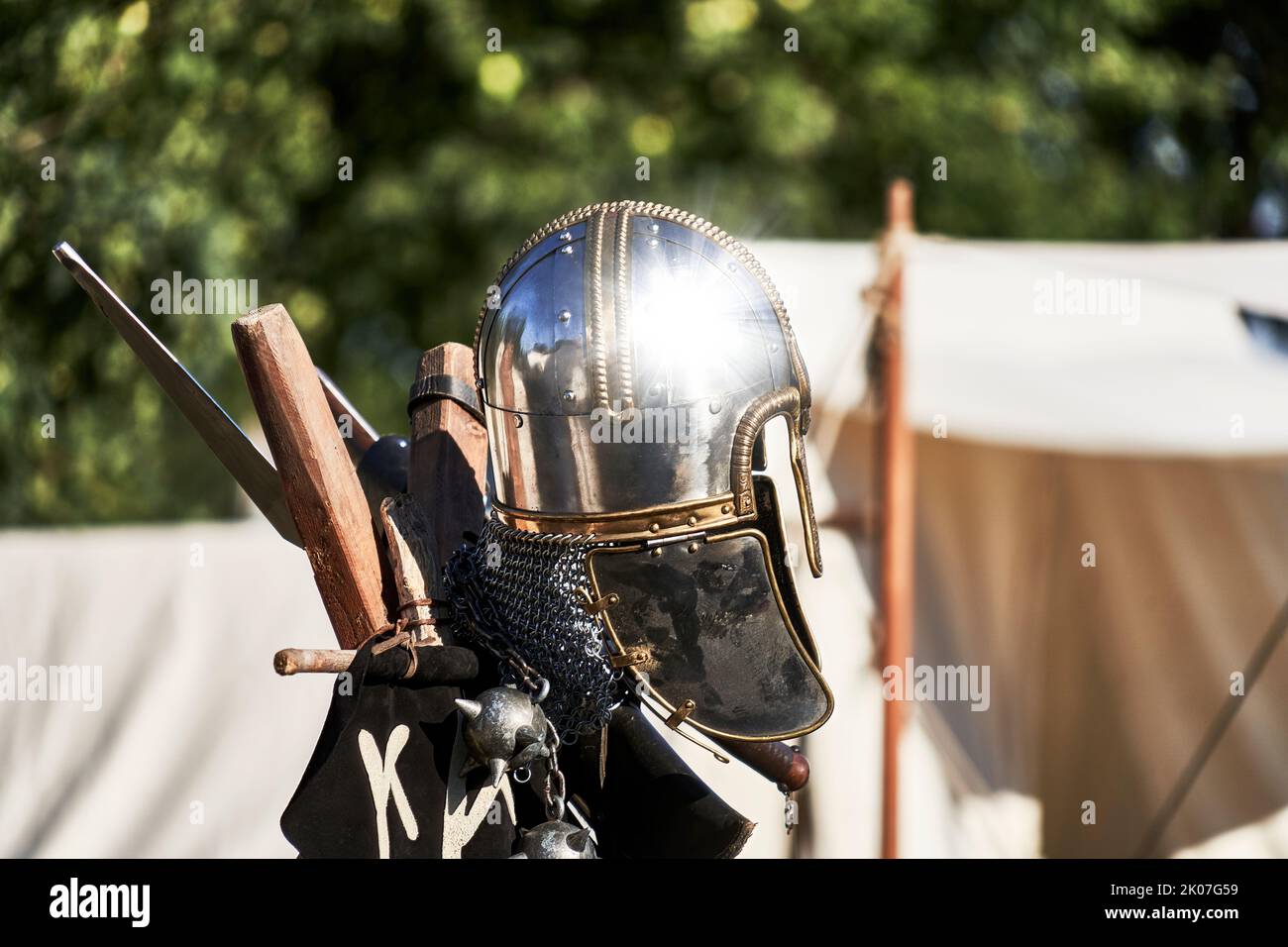 Bright shiny silver medieval knight helmet with reflections of sun rays ...