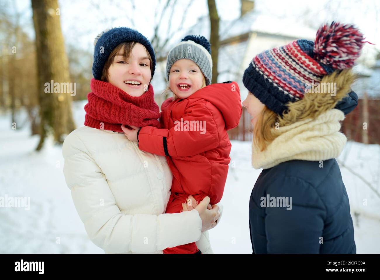 Two big sisters and their toddler brother having fun outdoors. Two ...
