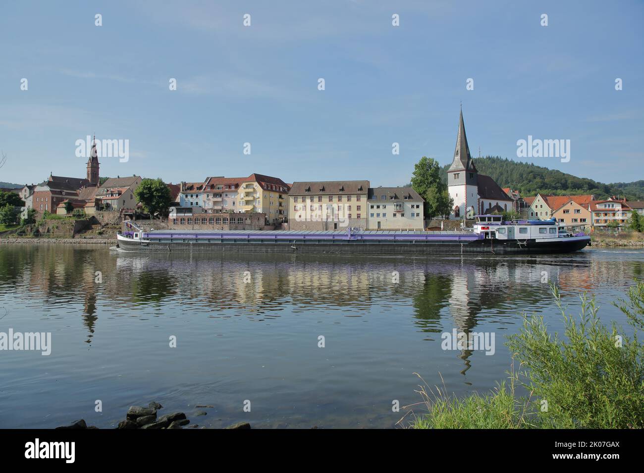 View of Neckargemuend riverside promenade and cargo ship in the Neckar ...