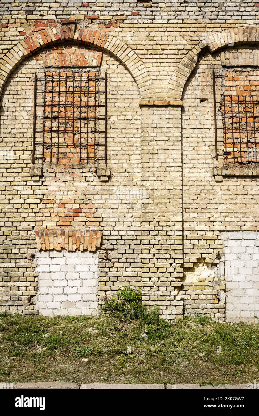 Old abandoned wall with bricked up windows. Architecture detail background. Forgotten building ...