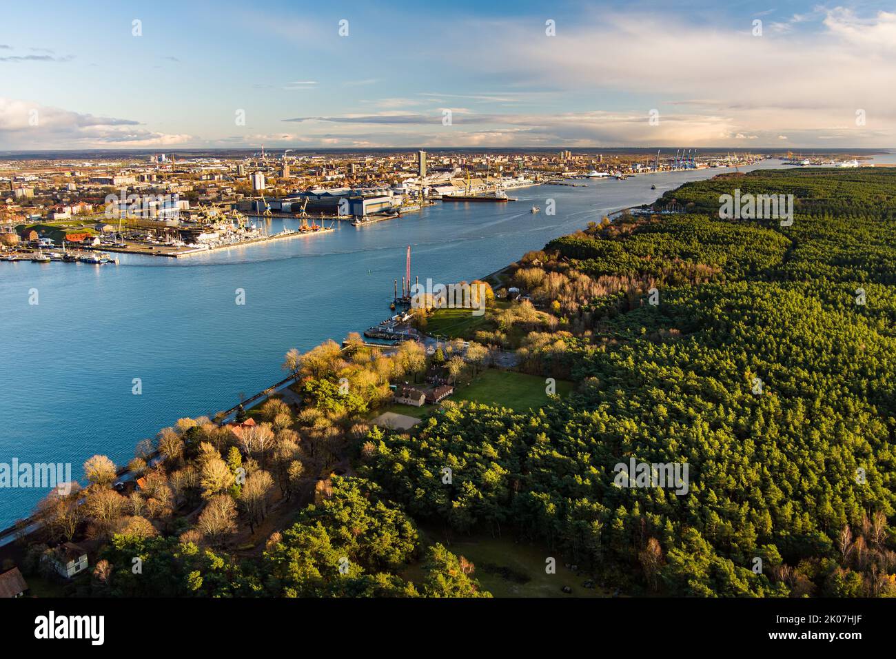 Aerial view of the Curonian spit covered by pine forests. Curved sand ...