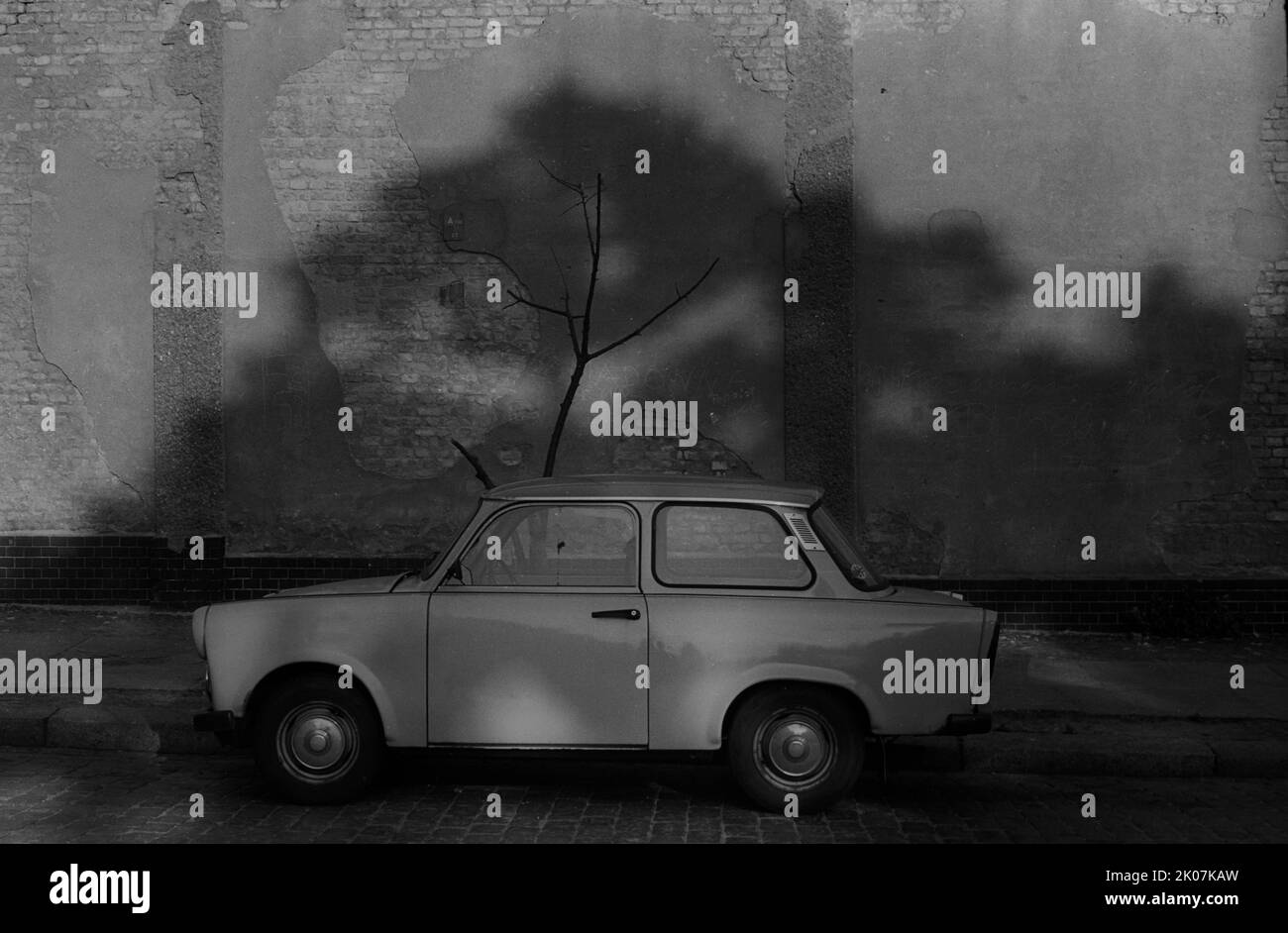GDR, Berlin, 28. 07. 1986, Trabant (Trabi) in front of wall with tree ...