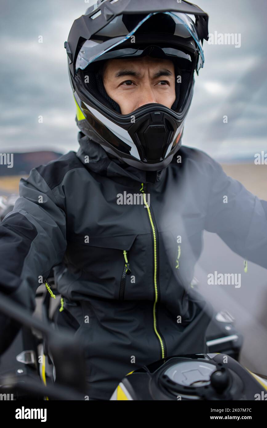 Chinese mid adult man riding motorcycle Stock Photo - Alamy