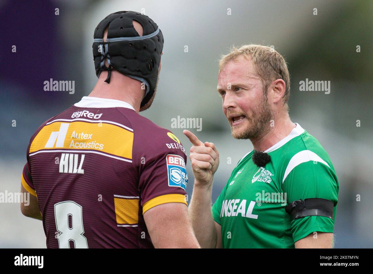 Referee Robert Hicks speaks with Chris Hill #8 of Huddersfield Giants ...