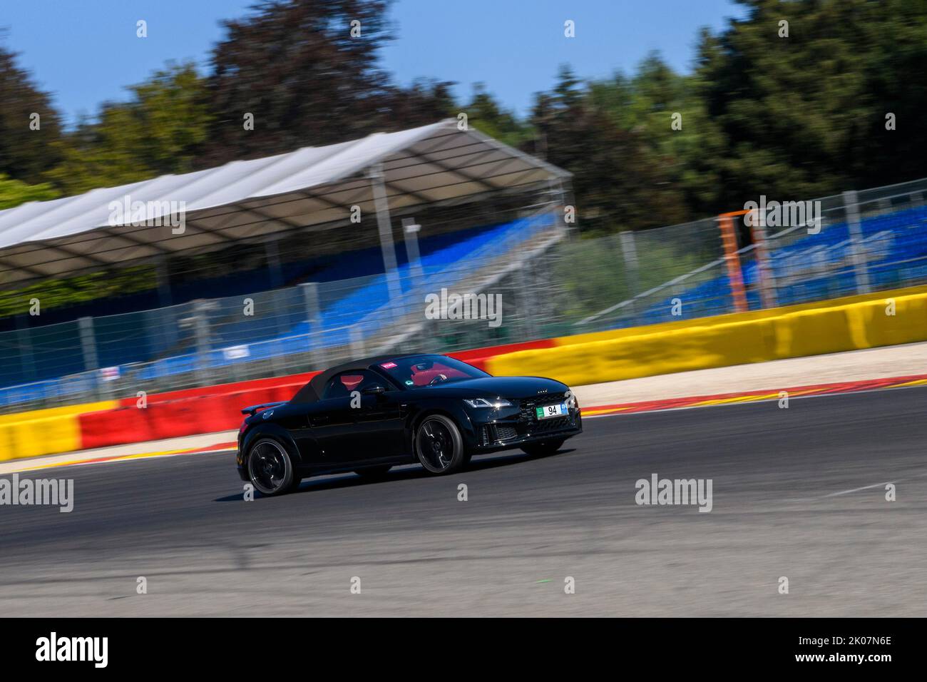 Racing car sports car Audi TT races at high speed full throttle at exit ...