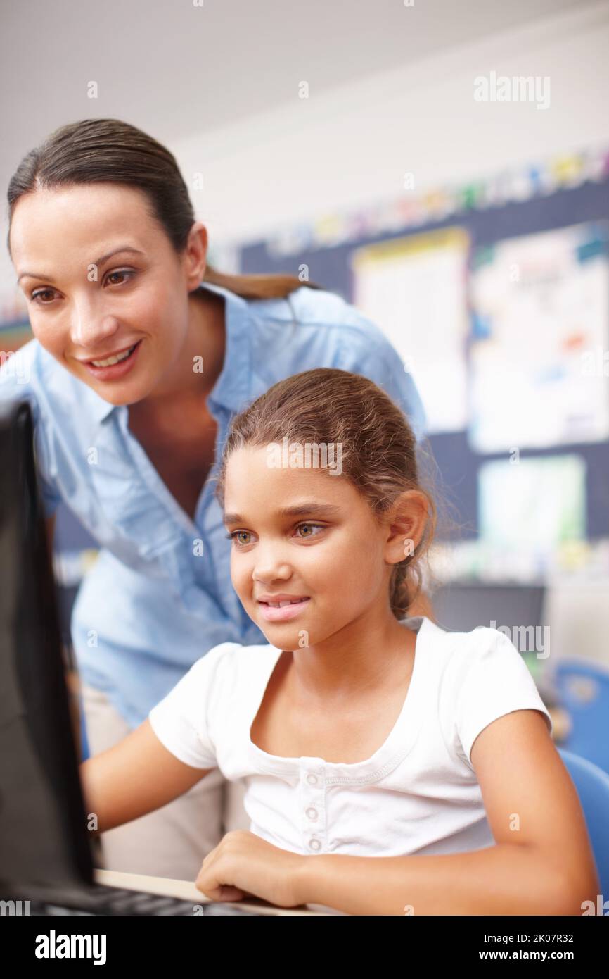 You have good computer skills. An attractive young teacher assisting a ...