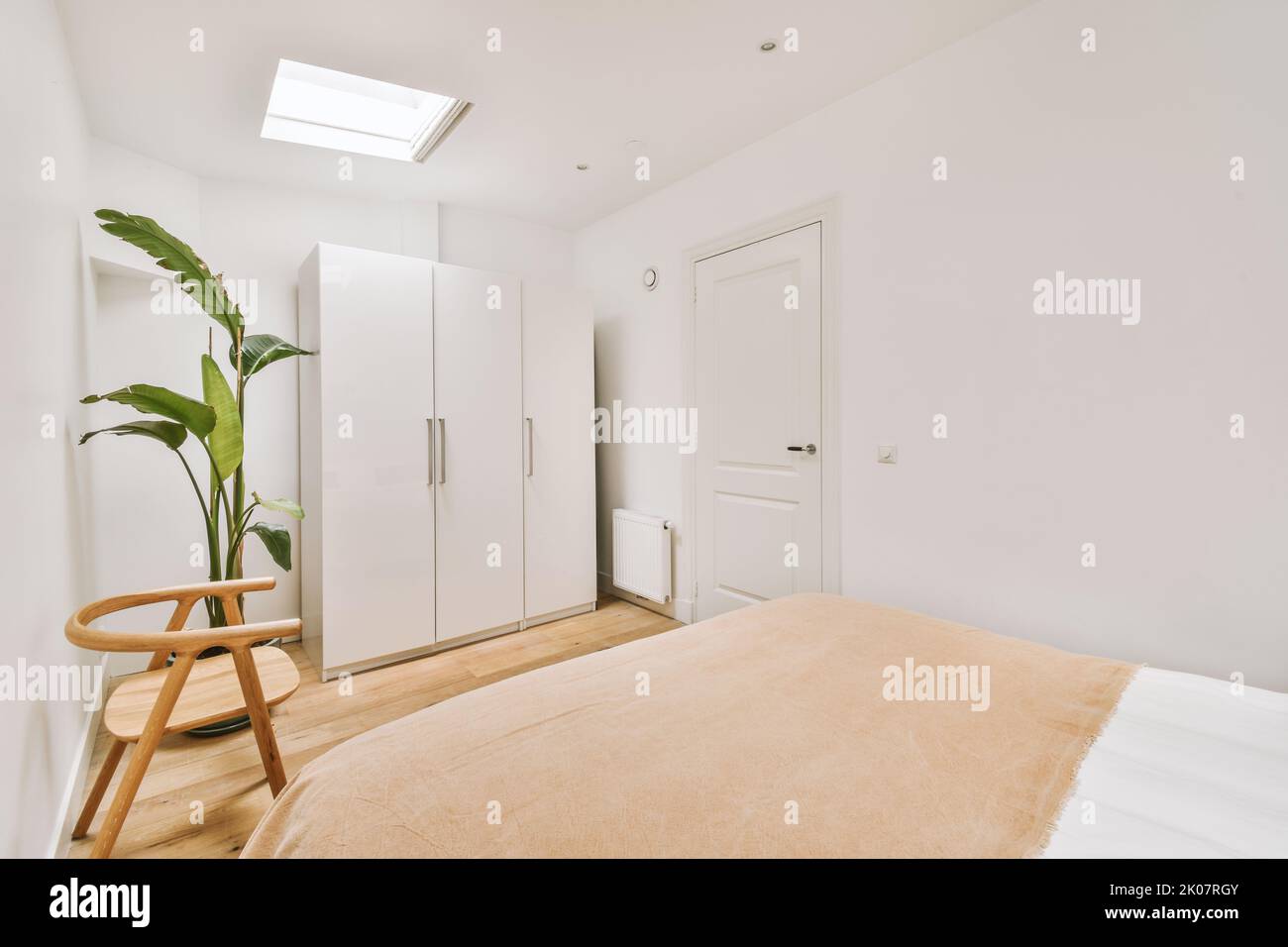 Home interior design of bedroom with bed and wooden wardrobe placed in ...