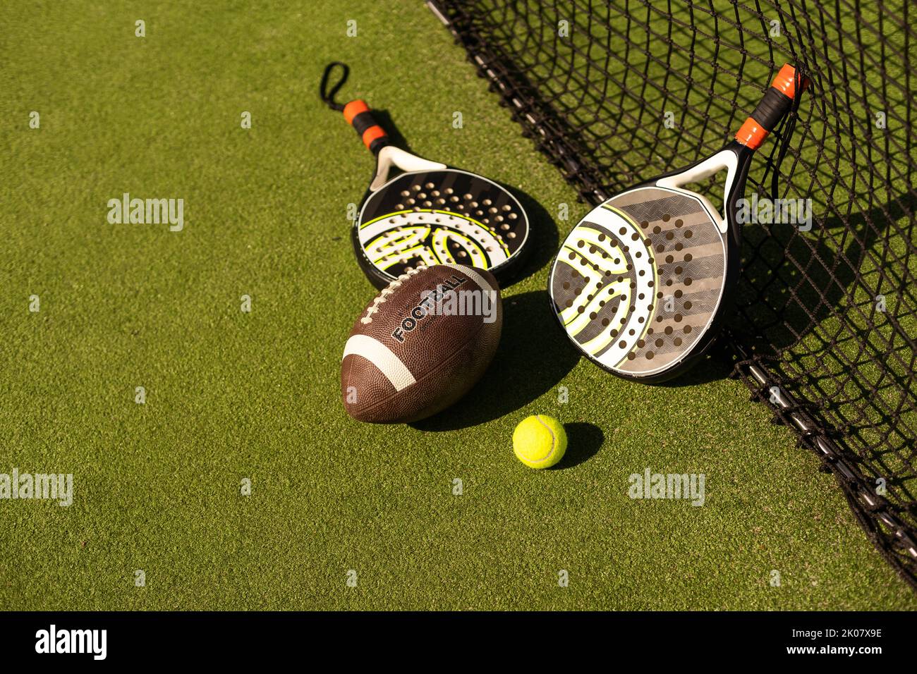 Sports equipment, rackets and balls on court floor Stock Photo - Alamy