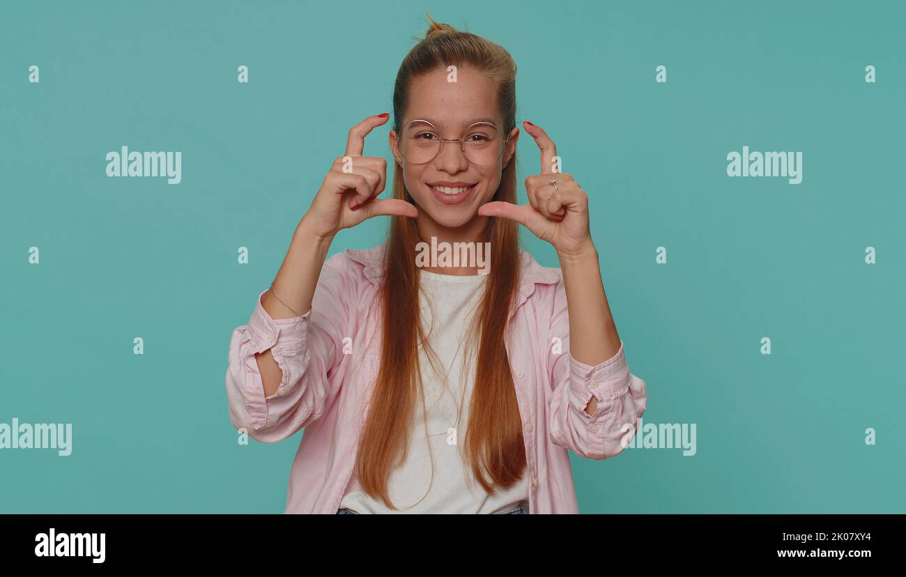 Teen young girl photographer gesturing picture frame with hands, looks ...
