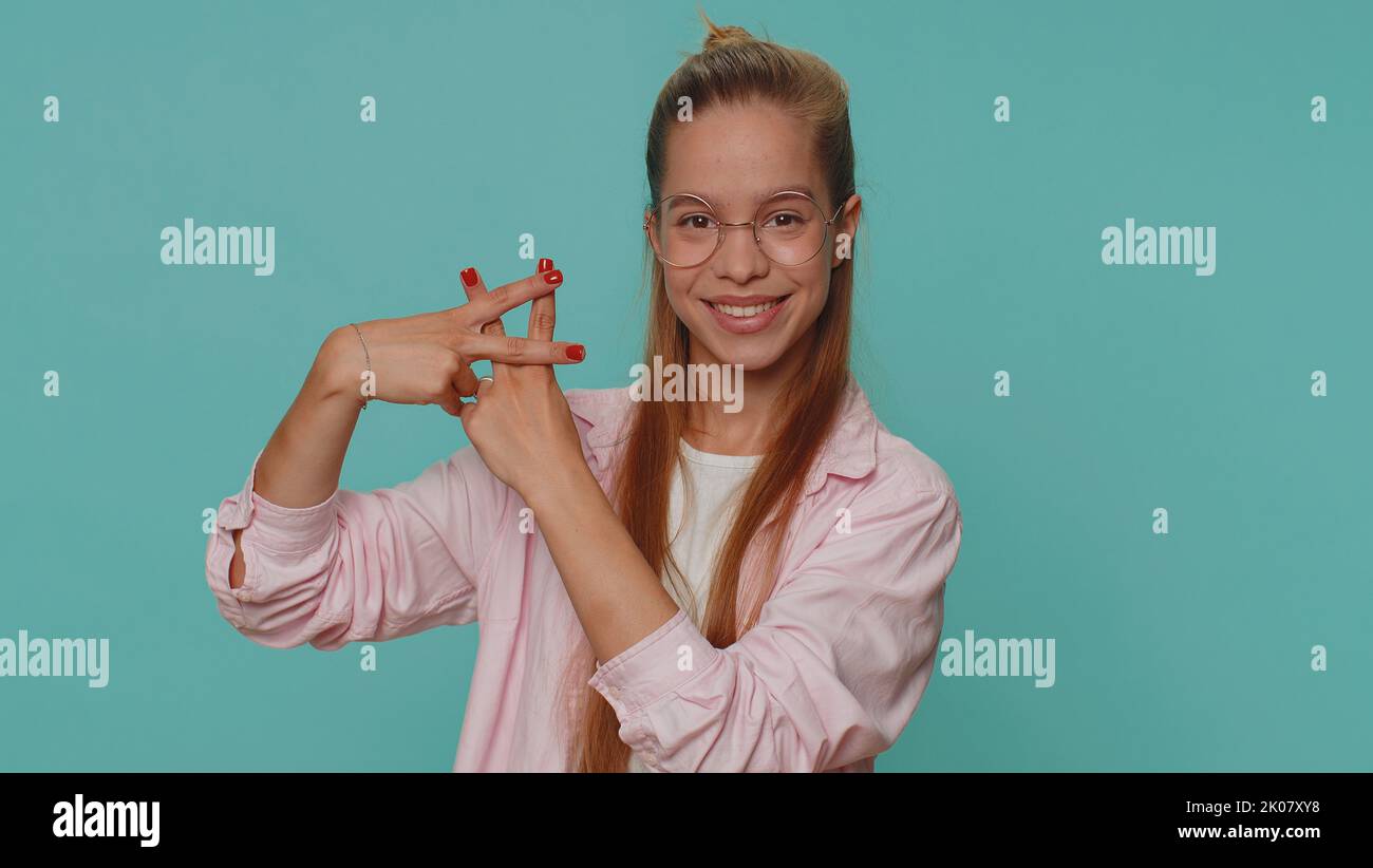 Hashtag. Cheerful pretty teenager young girl showing hashtag symbol ...