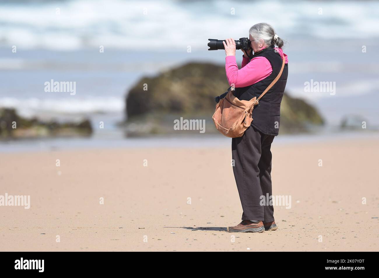 Photographer on beach photographing surfing competition Stock Photo - Alamy