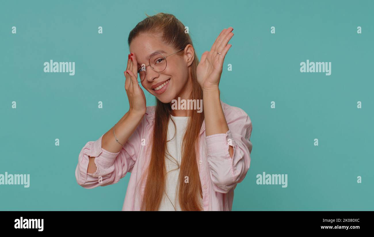 Nosy curious pretty teenager young girl closing eyes with hand and ...