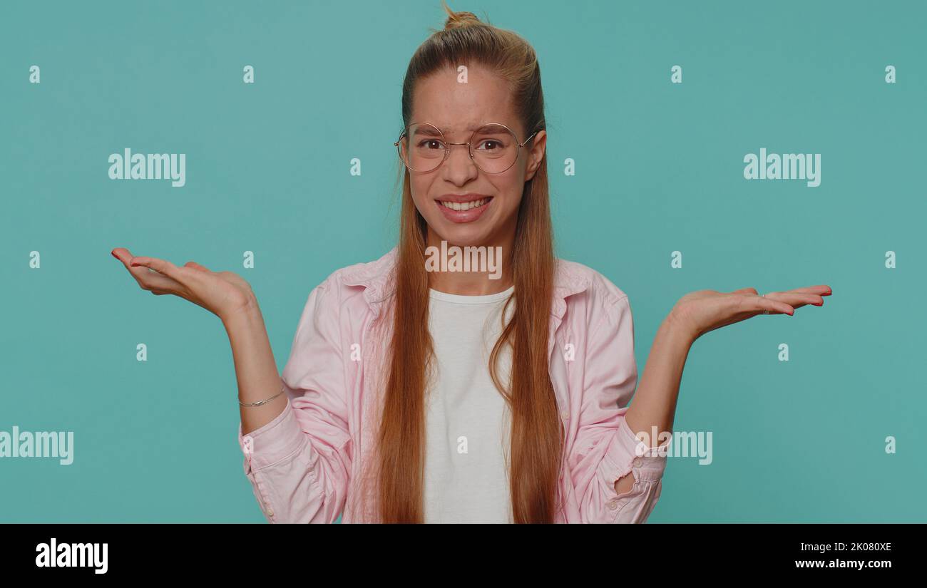 Pretty teenager girl raising hands in indignant expression, asking why ...