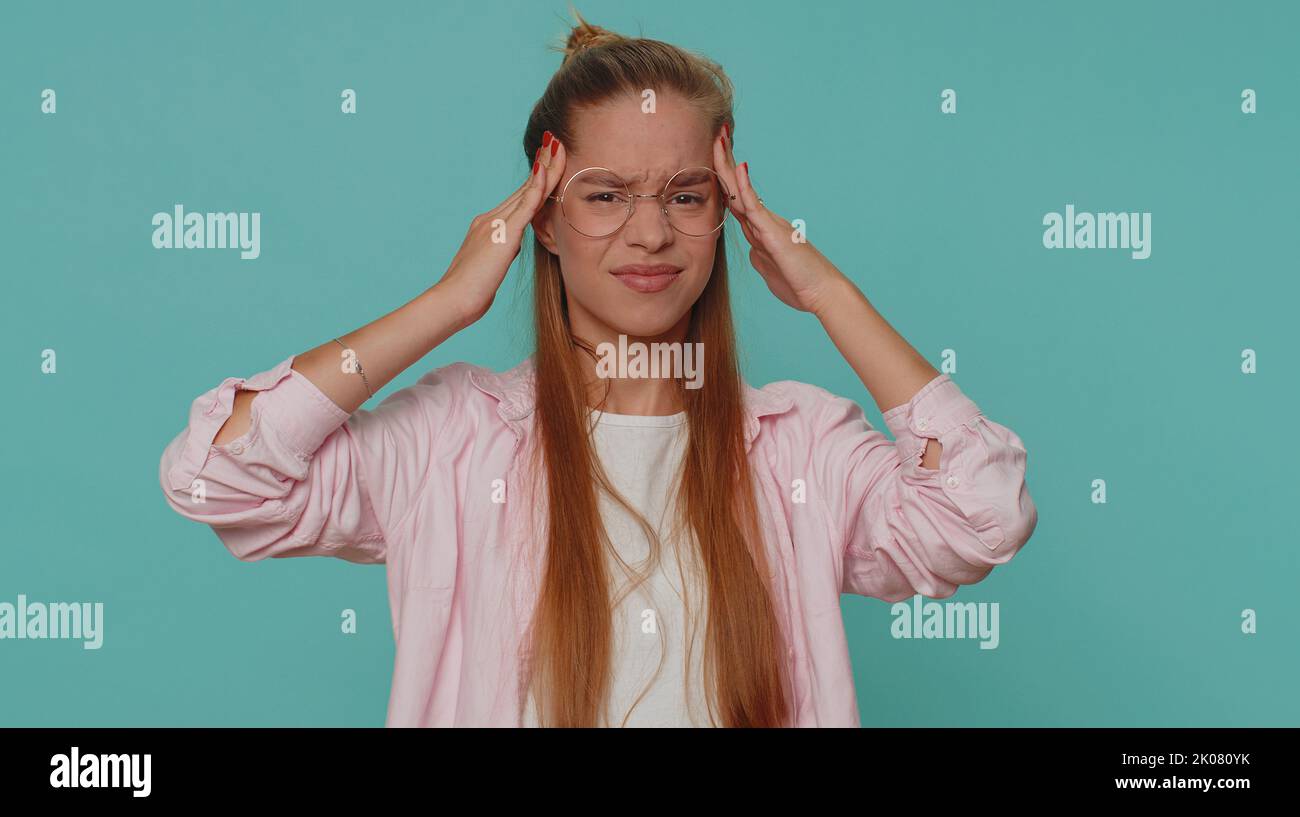 Displeased teenager young girl rubbing temples to cure headache problem ...