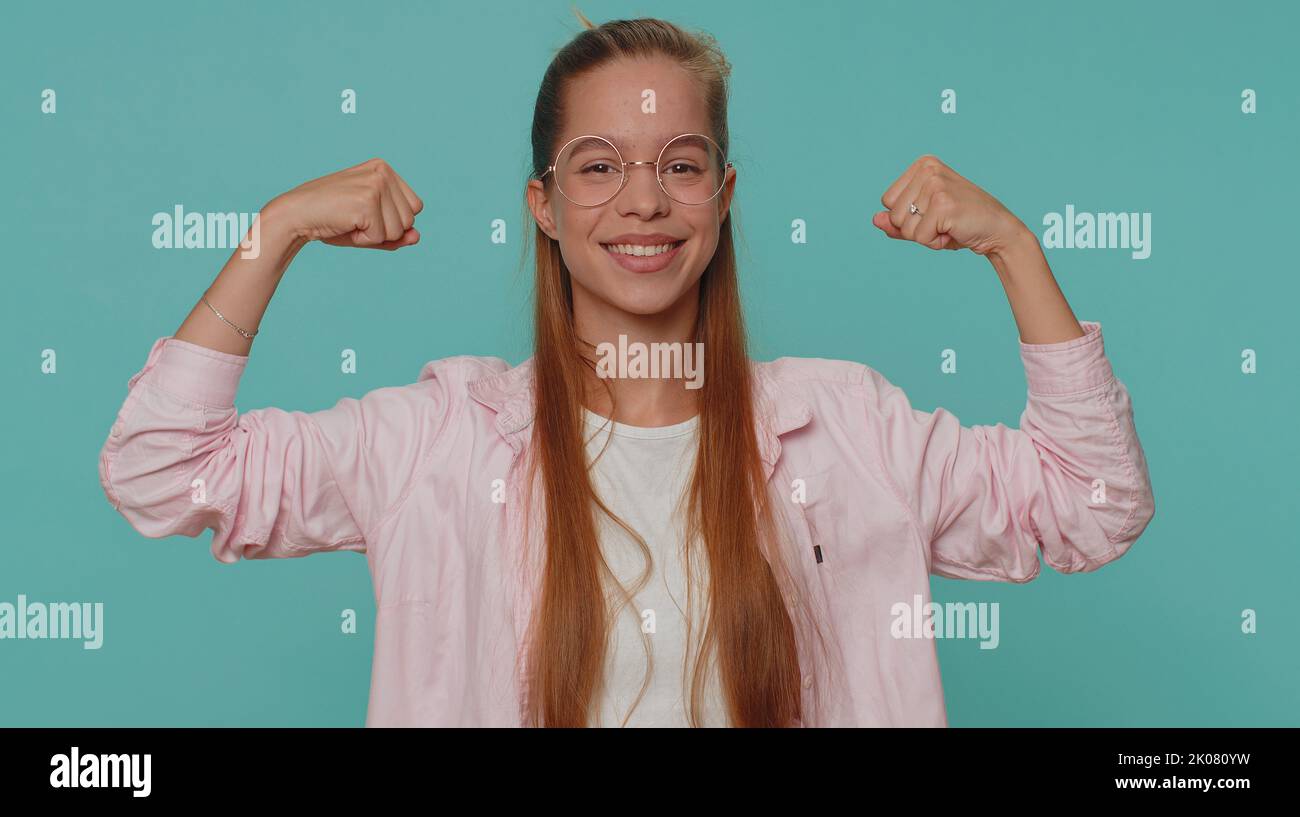I am strong and independent. Pretty teenager young girl showing biceps ...