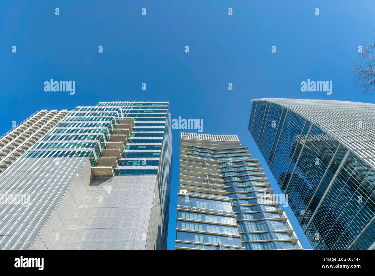 Skyscrapers with glass windowsat the facade reflecting building and ...