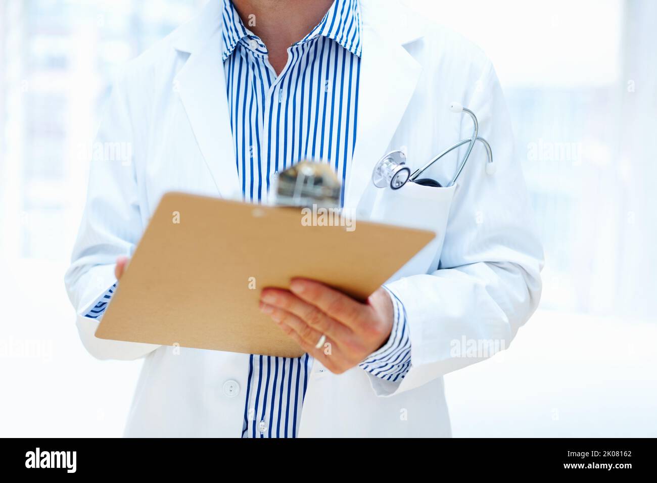 Doctor writing down prognosis. Closeup of doctor writing a prescription ...